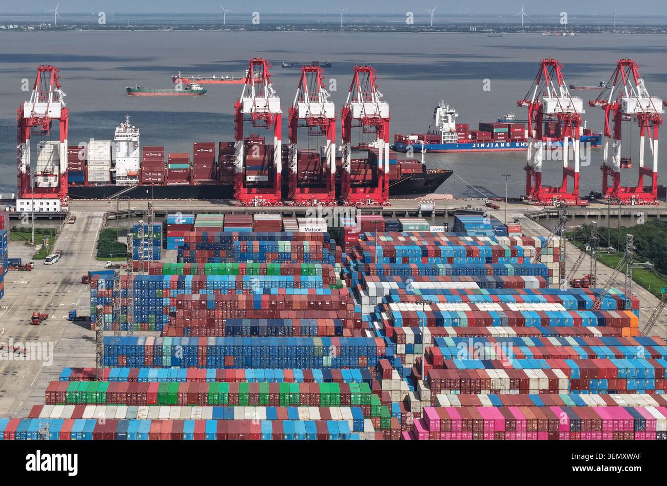 Containers are handled at a busy foreign trade terminal in Shanghai ...