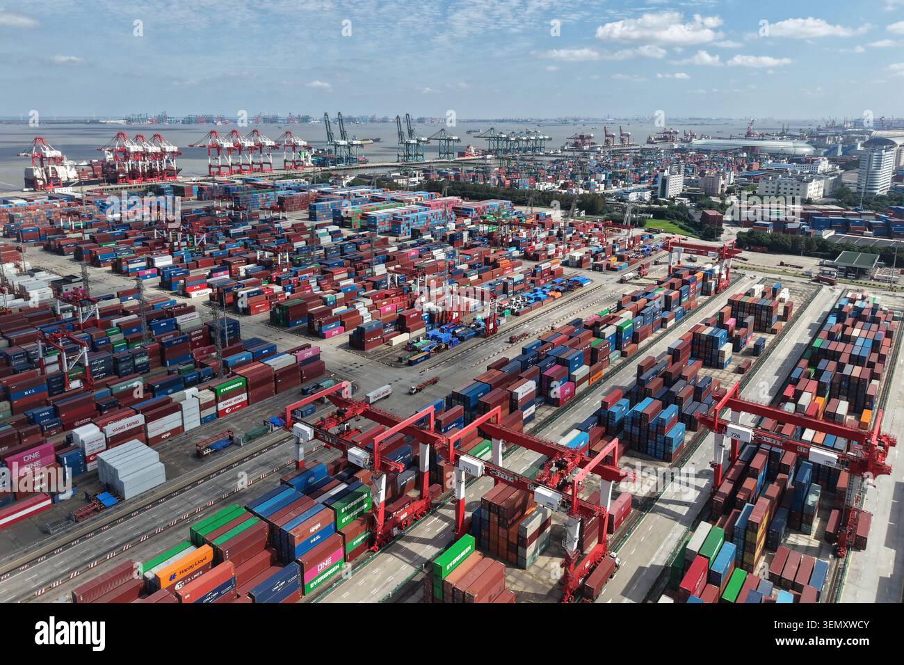 Containers are handled at a busy foreign trade terminal in Shanghai ...
