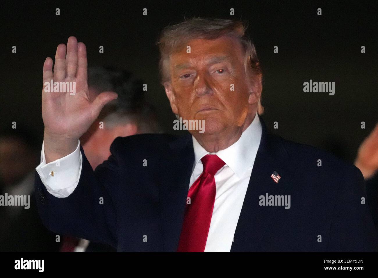 President Donald Trump gestures as he steps off Air Force One, early ...