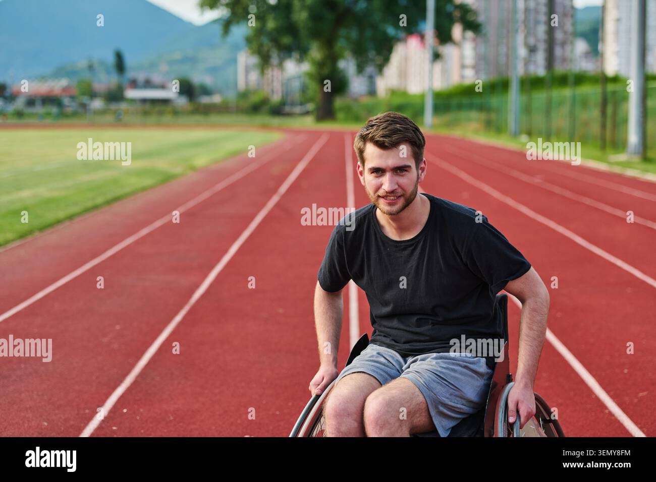 Young Man in Wheelchair Training on Outdoor Running Track Showing ...