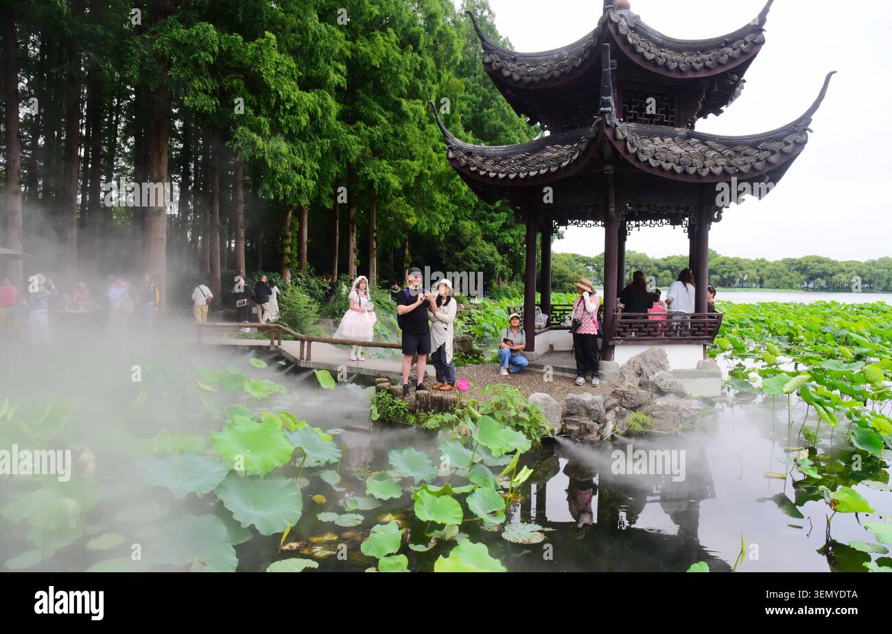 Visitors enjoy the misty lotus ponds at Quyuan Fenghe Scenic Area in ...