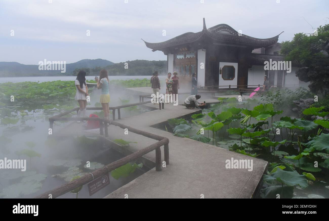 Visitors enjoy the misty lotus ponds at Quyuan Fenghe Scenic Area in ...