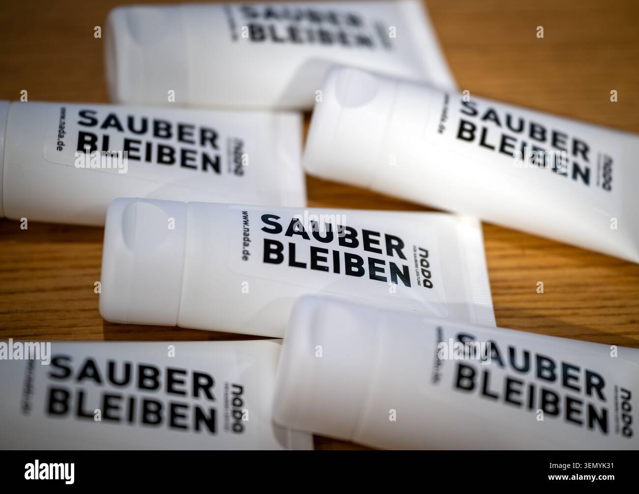 09 June 2026, Berlin: White tubes of shower gel with the inscription ...