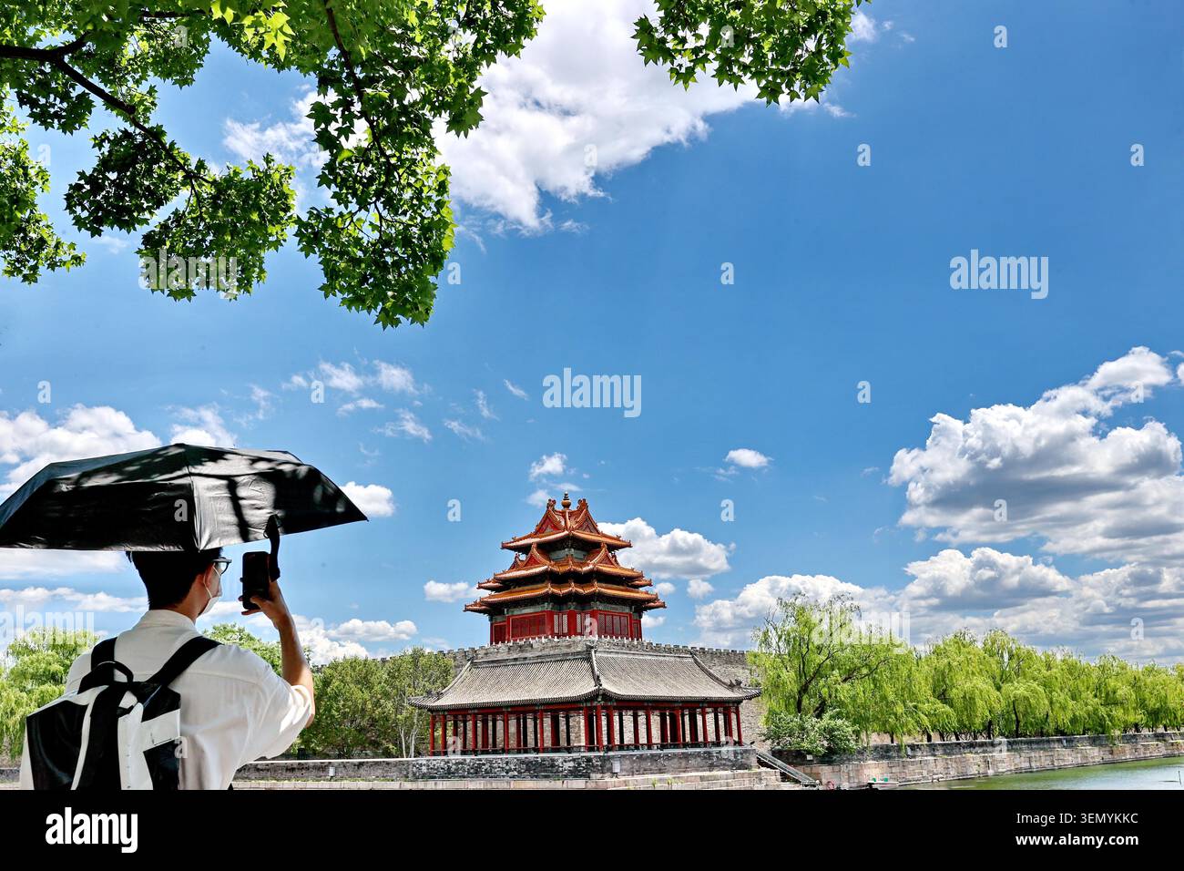 Tourists take photos of the Forbidden City's corner tower against clear ...
