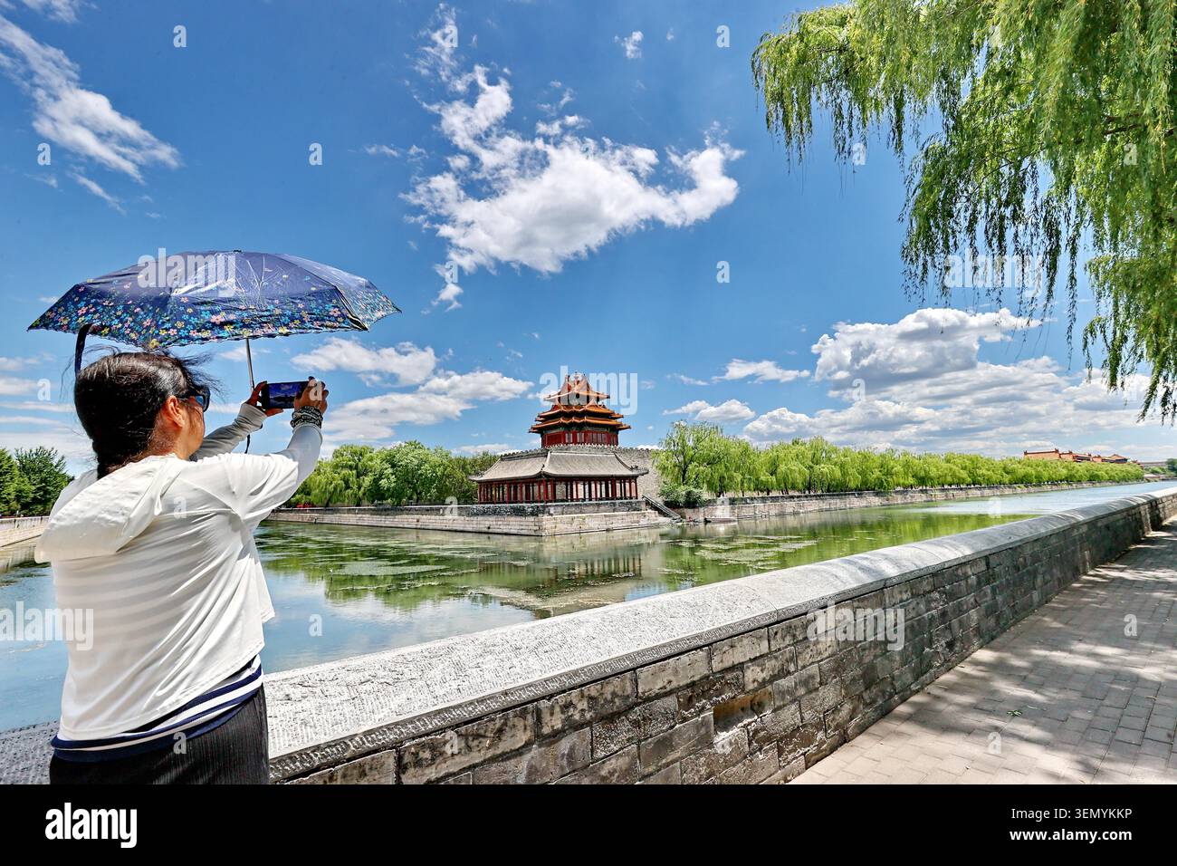 Tourists take photos of the Forbidden City's corner tower against clear ...