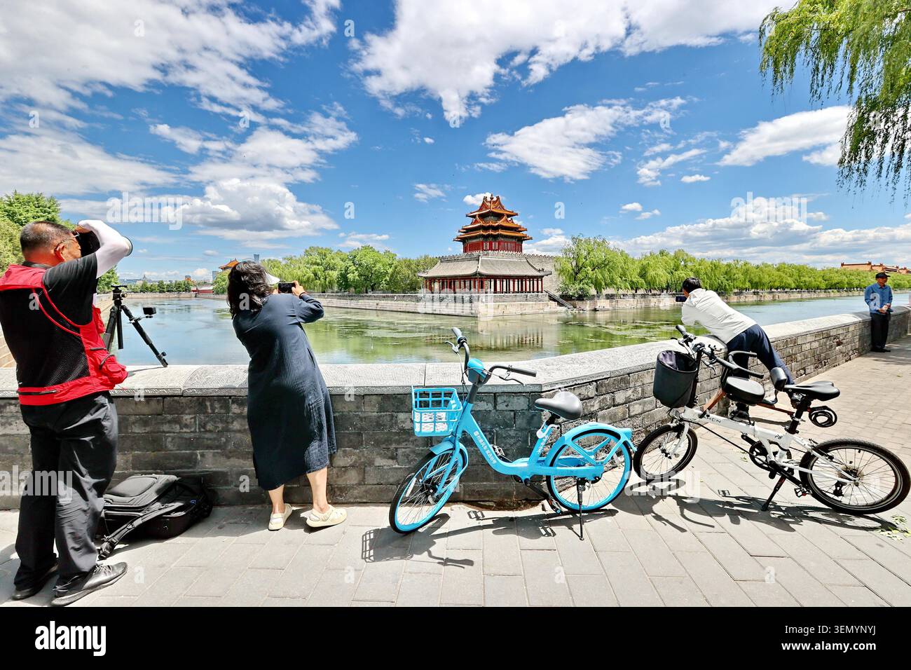 Tourists take photos of the Forbidden City's corner tower against clear ...