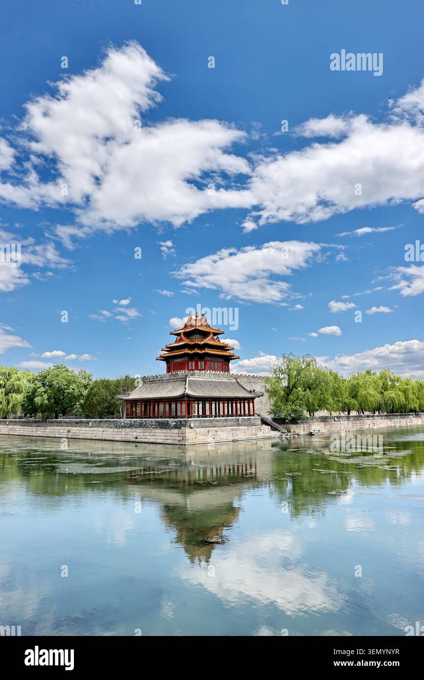 Tourists take photos of the Forbidden City's corner tower against blue ...