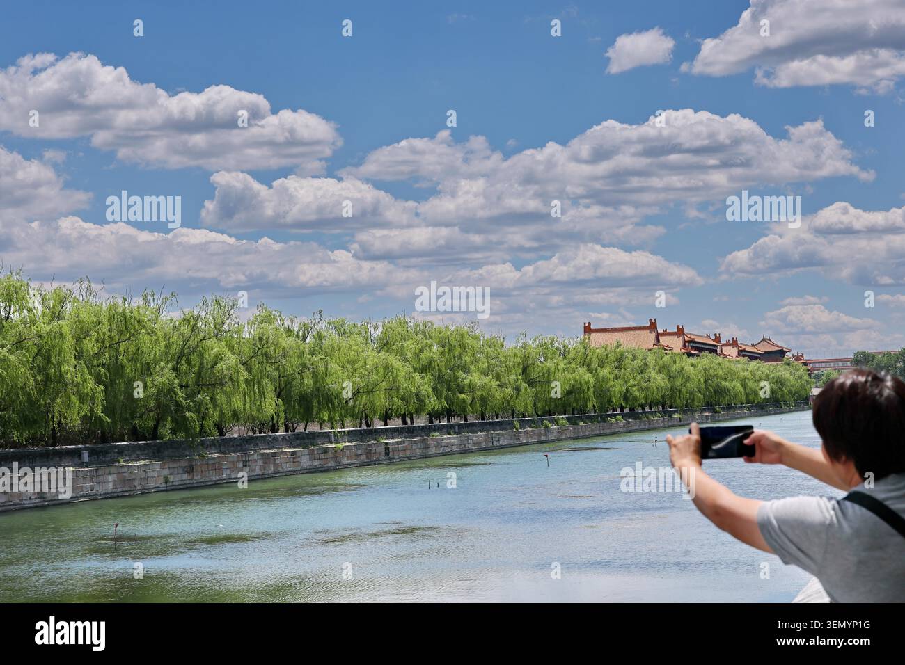 Tourists take photos of the Forbidden City's corner tower against clear ...