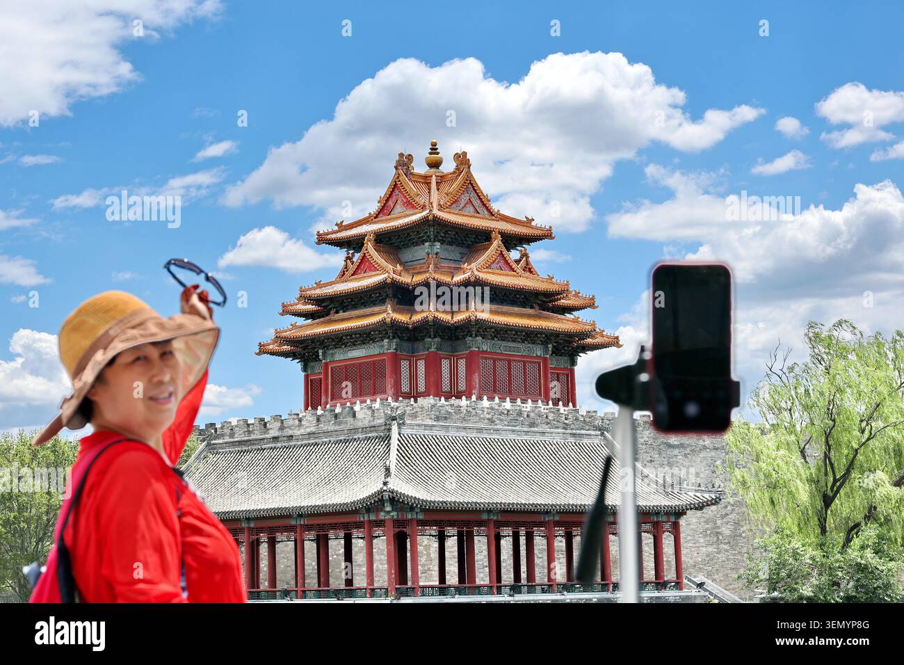 Tourists take photos of the Forbidden City's corner tower against clear ...