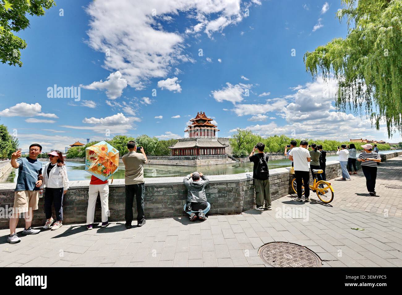 Tourists take photos of the Forbidden City's corner tower against clear ...