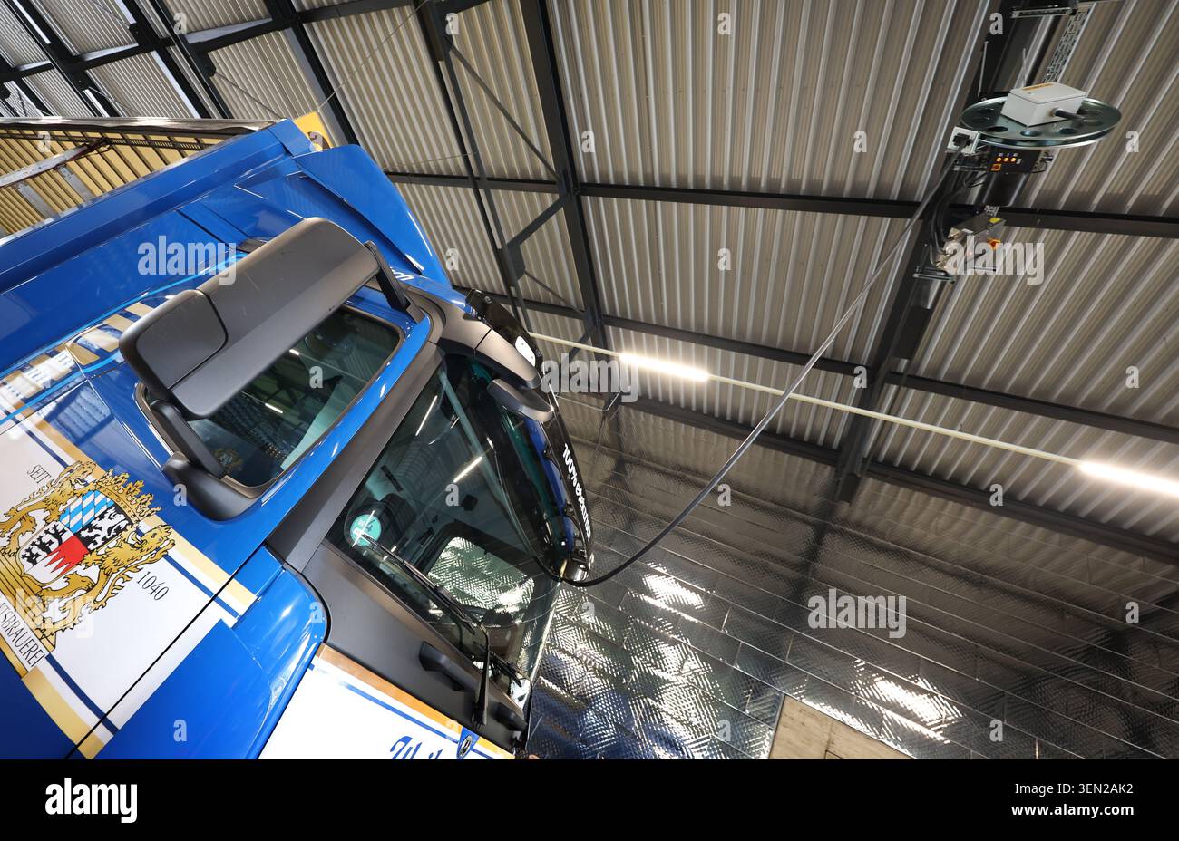 09 June 2026, Bavaria, Freising: An electric truck is charged with ...