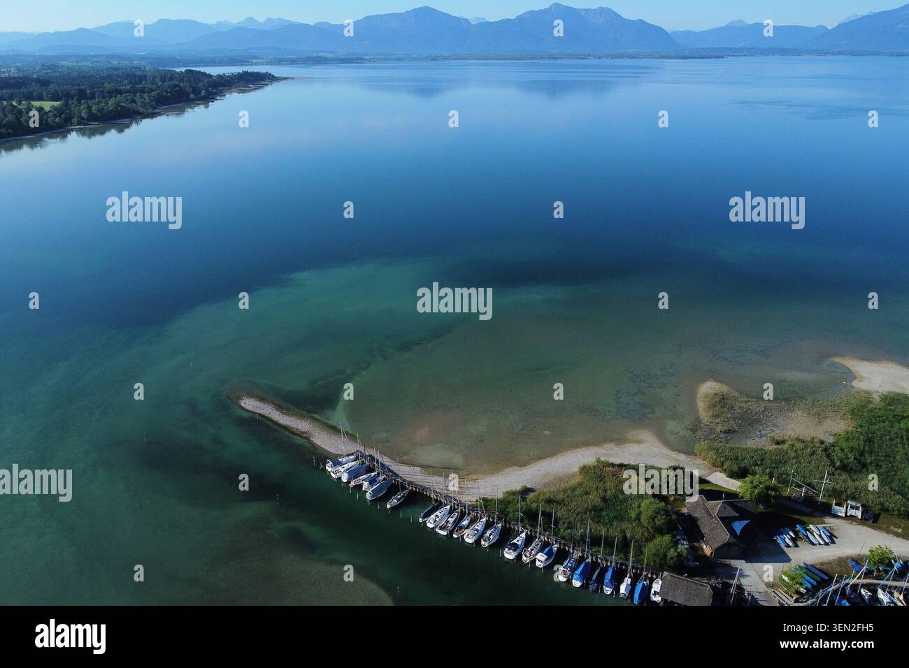Boats sit docked during low water at lake 'Chiemsee' in Seebruck ...