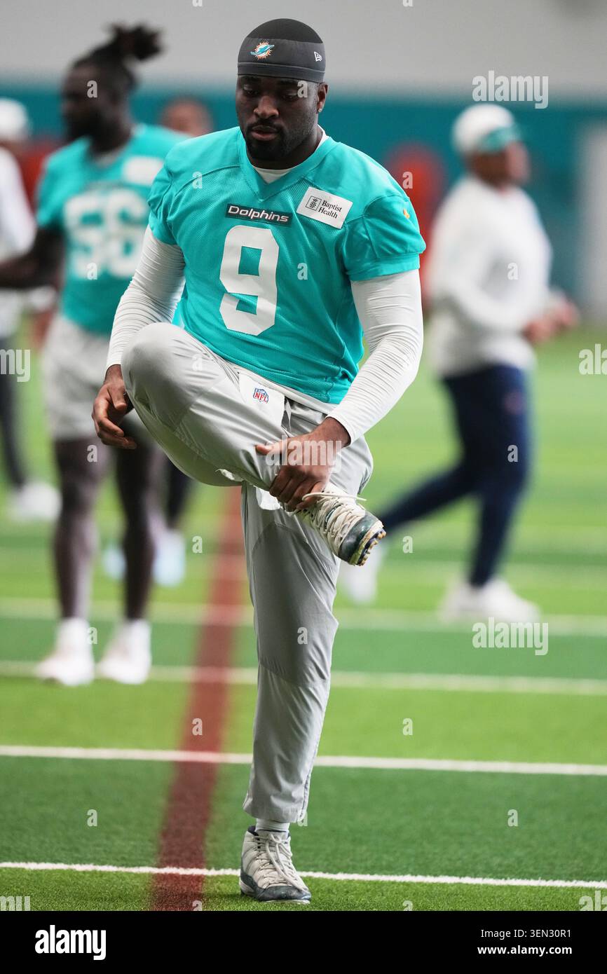 Miami Dolphins edge Josh Uche (9) stretches during an NFL football ...