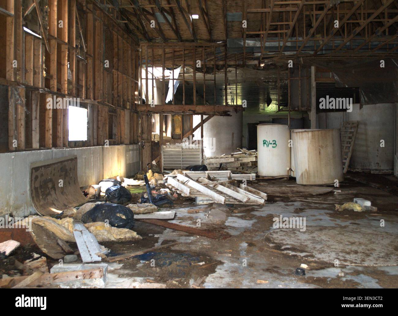 Vats of fermenting fish are shown in a long-abandoned fish-sauce plant ...
