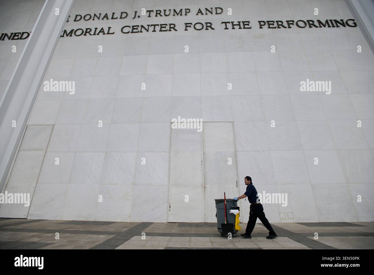 A man pushes a garbage can outside of The John. F. Kennedy Center for ...