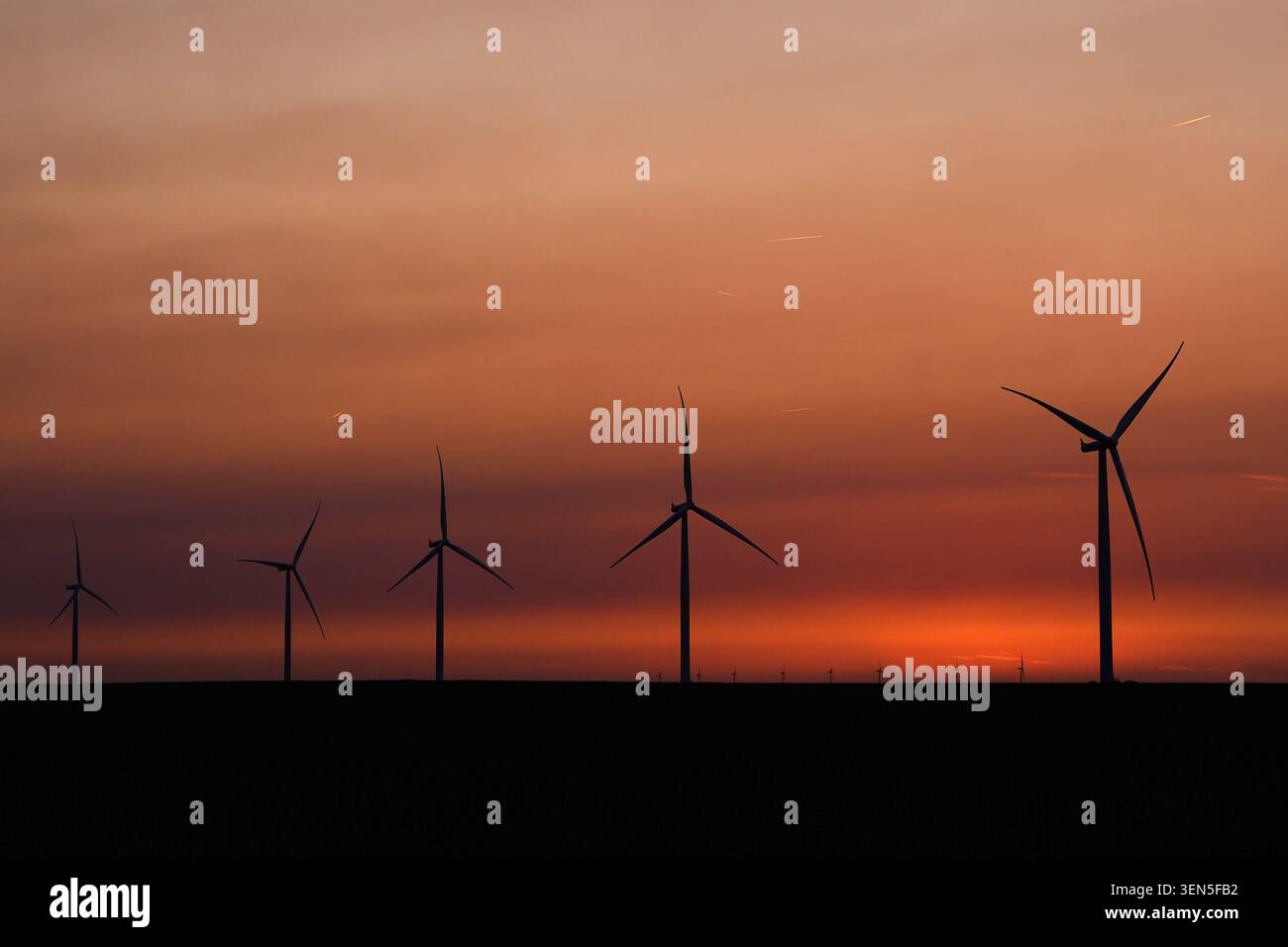 FILE - Wind turbines are silhouetted against the sky at dusk May 15 ...