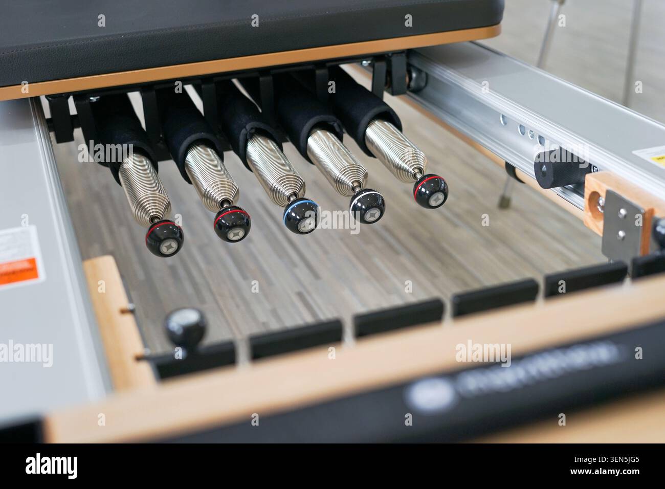Close-up view of heavy-duty metallic tension springs on a Pilates ...