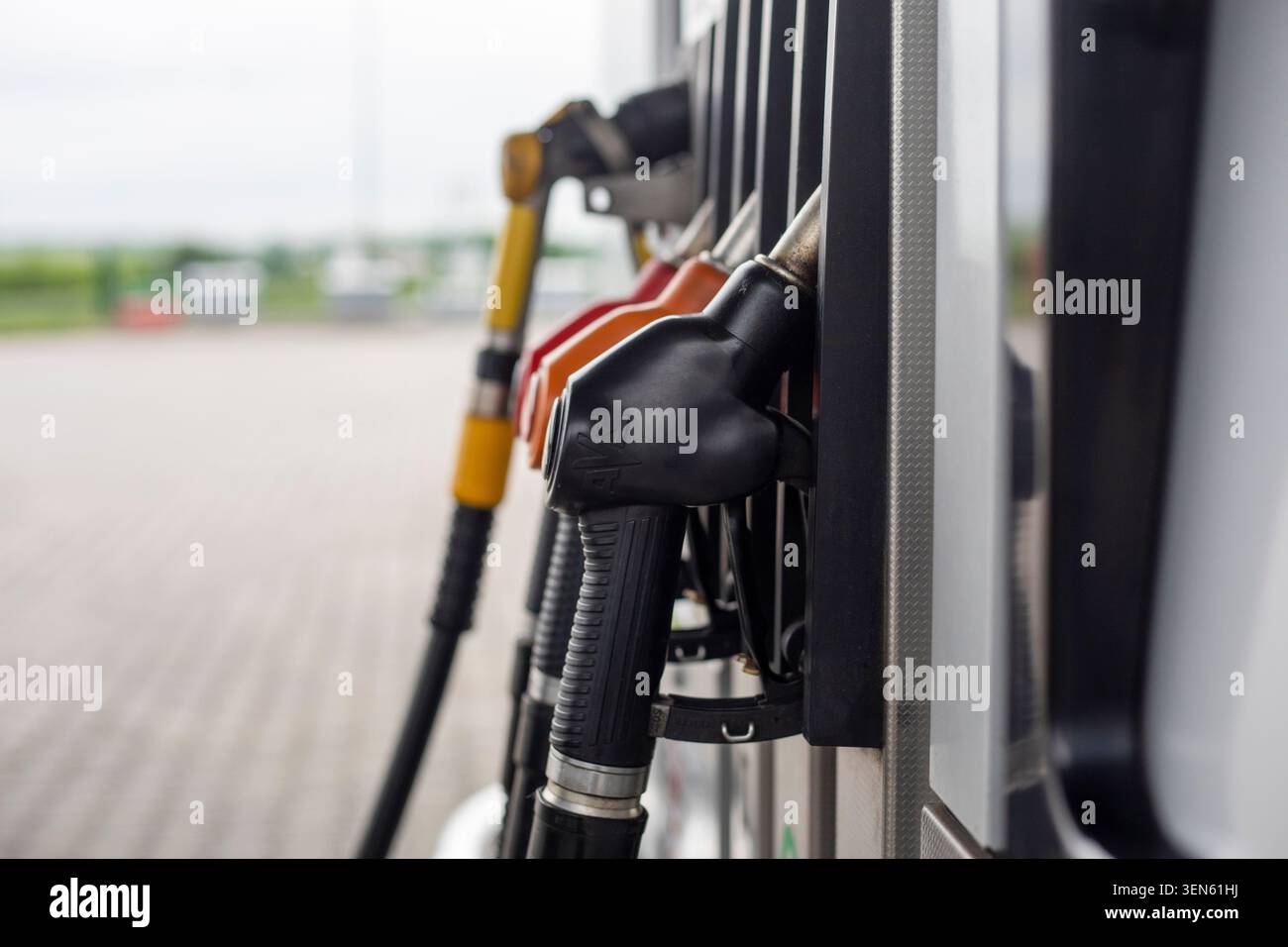 Gas nozzles at a gas station. Rising oil prices Stock Photo - Alamy
