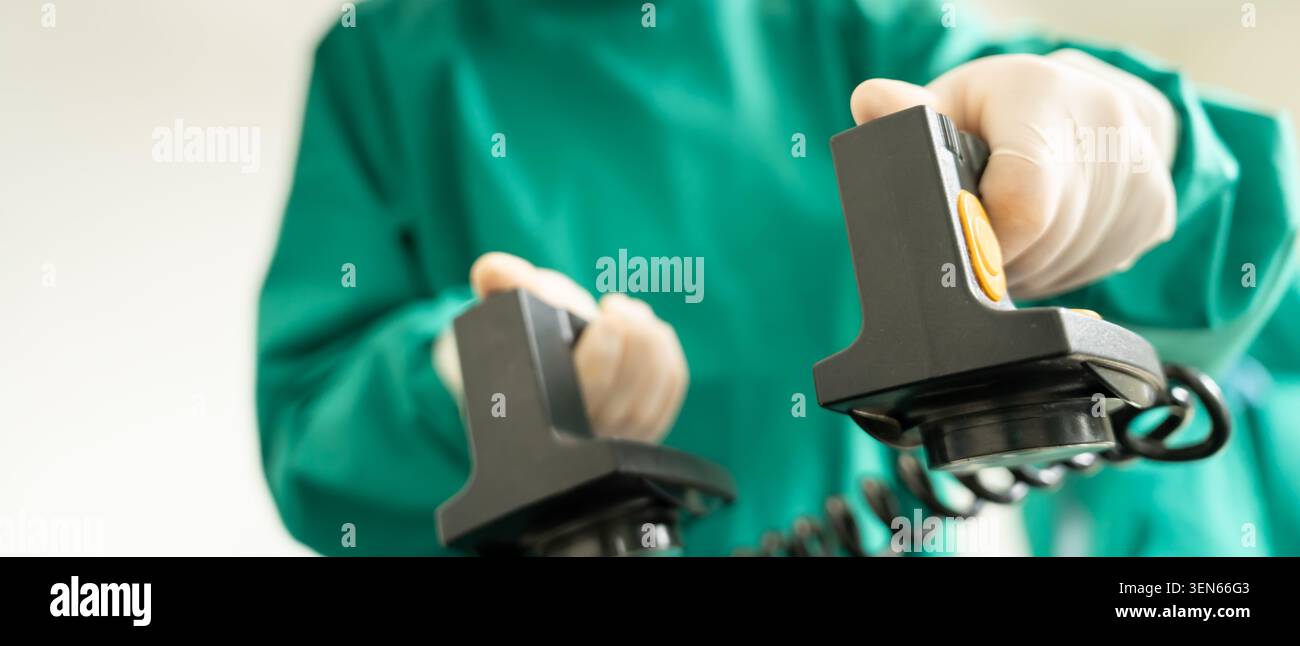 Medical urgency in the ambulance. Emergency doctor using defibrillator ...