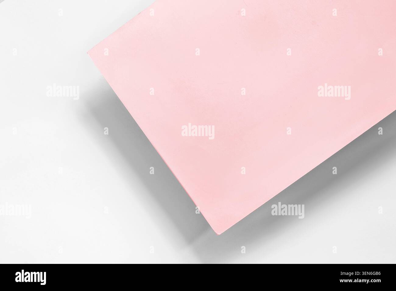 Blank pastel pink paper sheet over white paper background Stock Photo ...