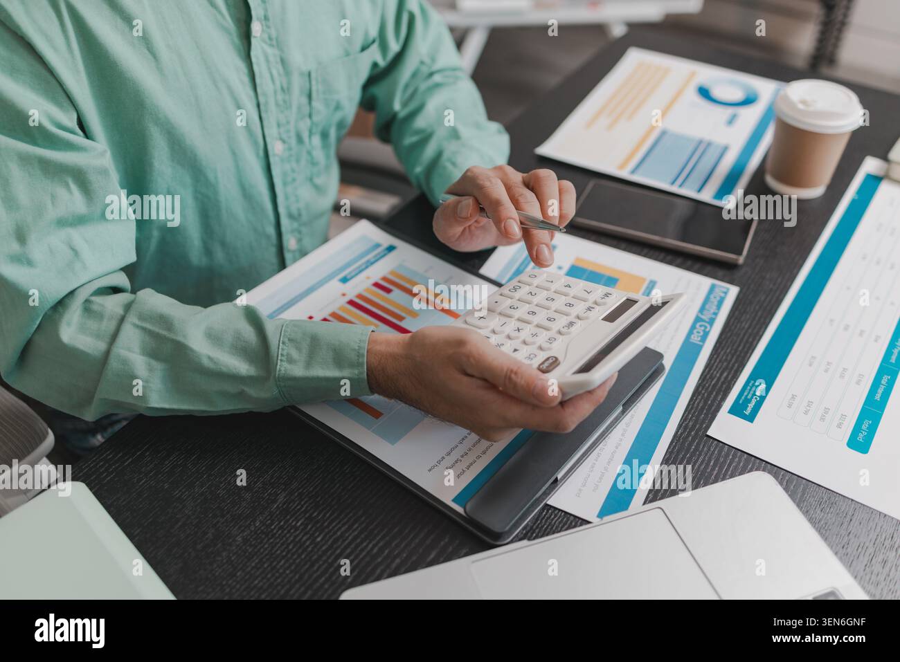 Business professional analyzing financial reports, reviewing ...