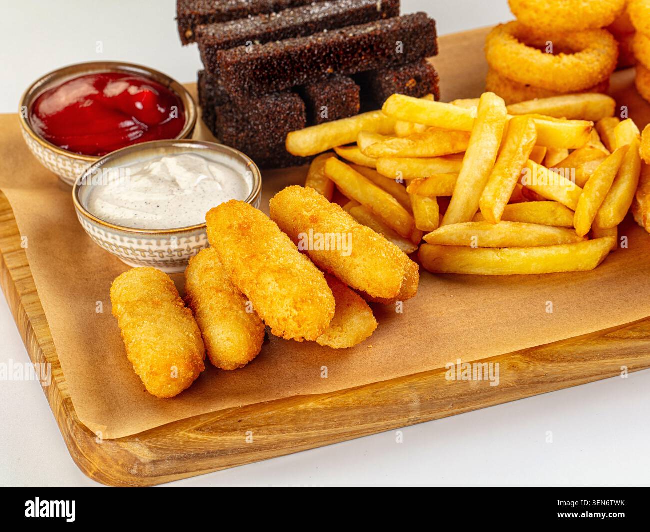Crispy golden fries, nuggets, onion rings, and dark bread slices served ...