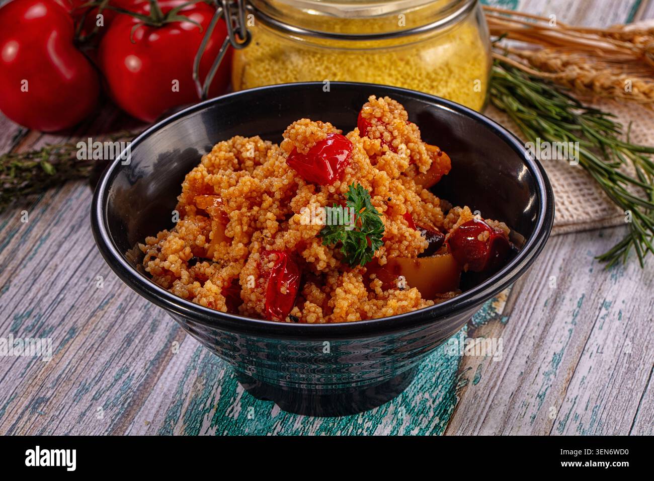 Couscous with roasted tomatoes and vegetables in a bowl. Fresh ...