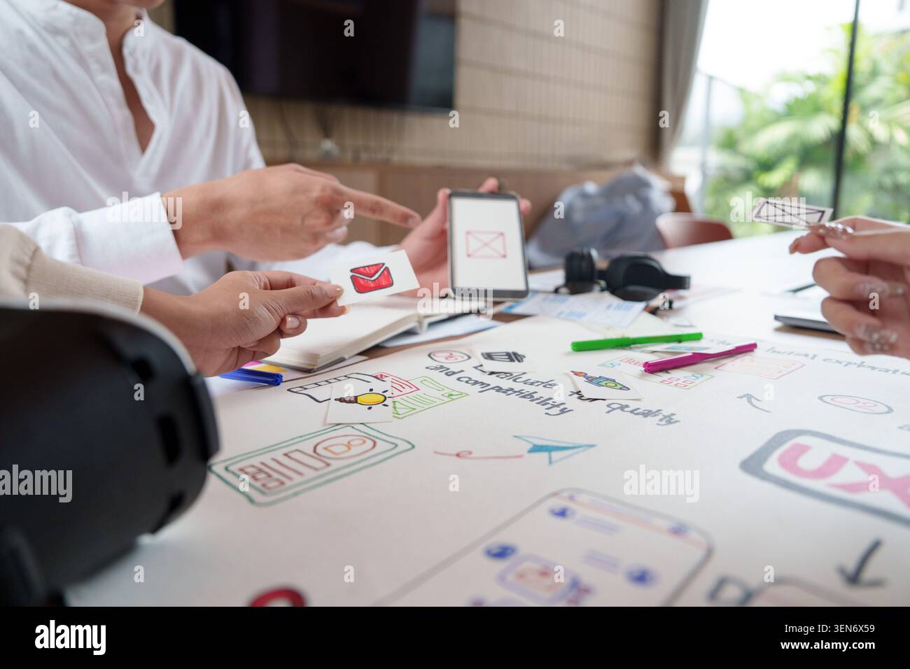 Business team hands collaborating on UI UX design creative process with ...