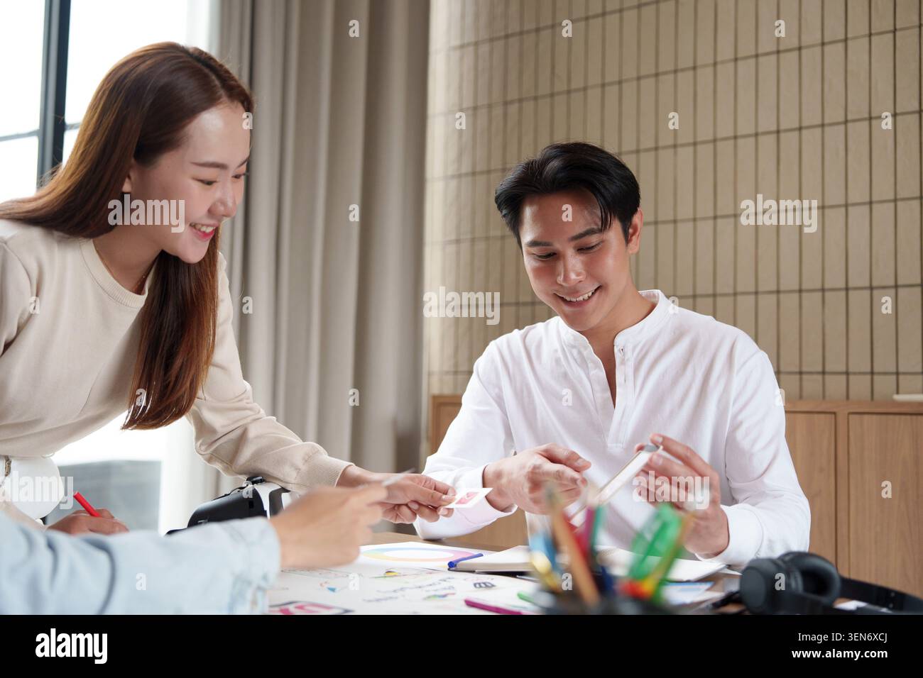 Asian business team collaborating on UI UX design creative process in ...