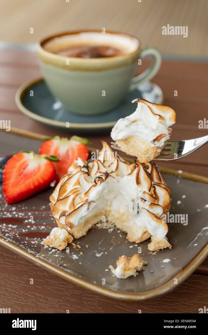 Delicious Dessert With Meringue Topping and Coffee on a Wooden Table ...