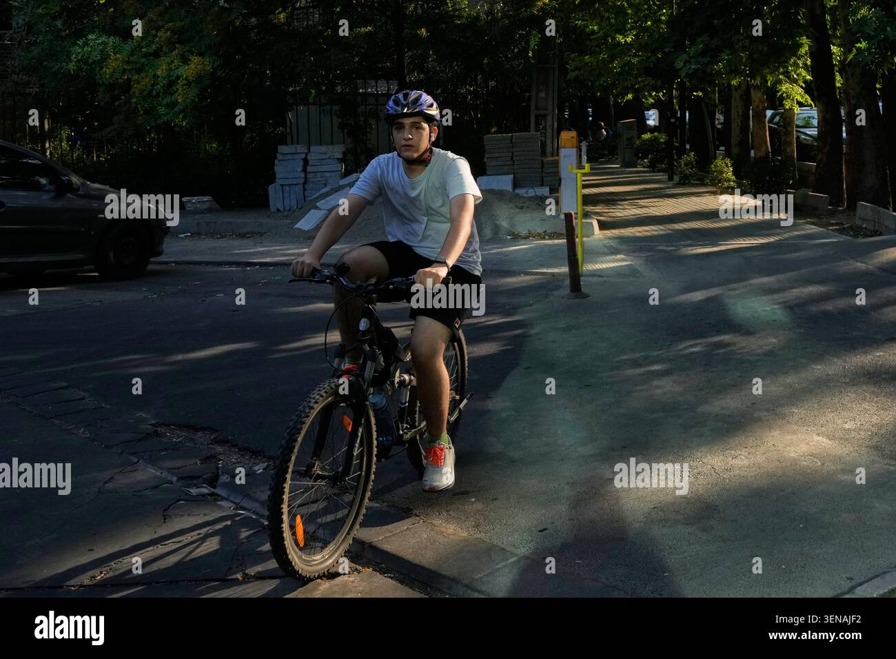 A man rides a bicycle in northern Tehran, Wednesday, June 10, 2026. (AP ...