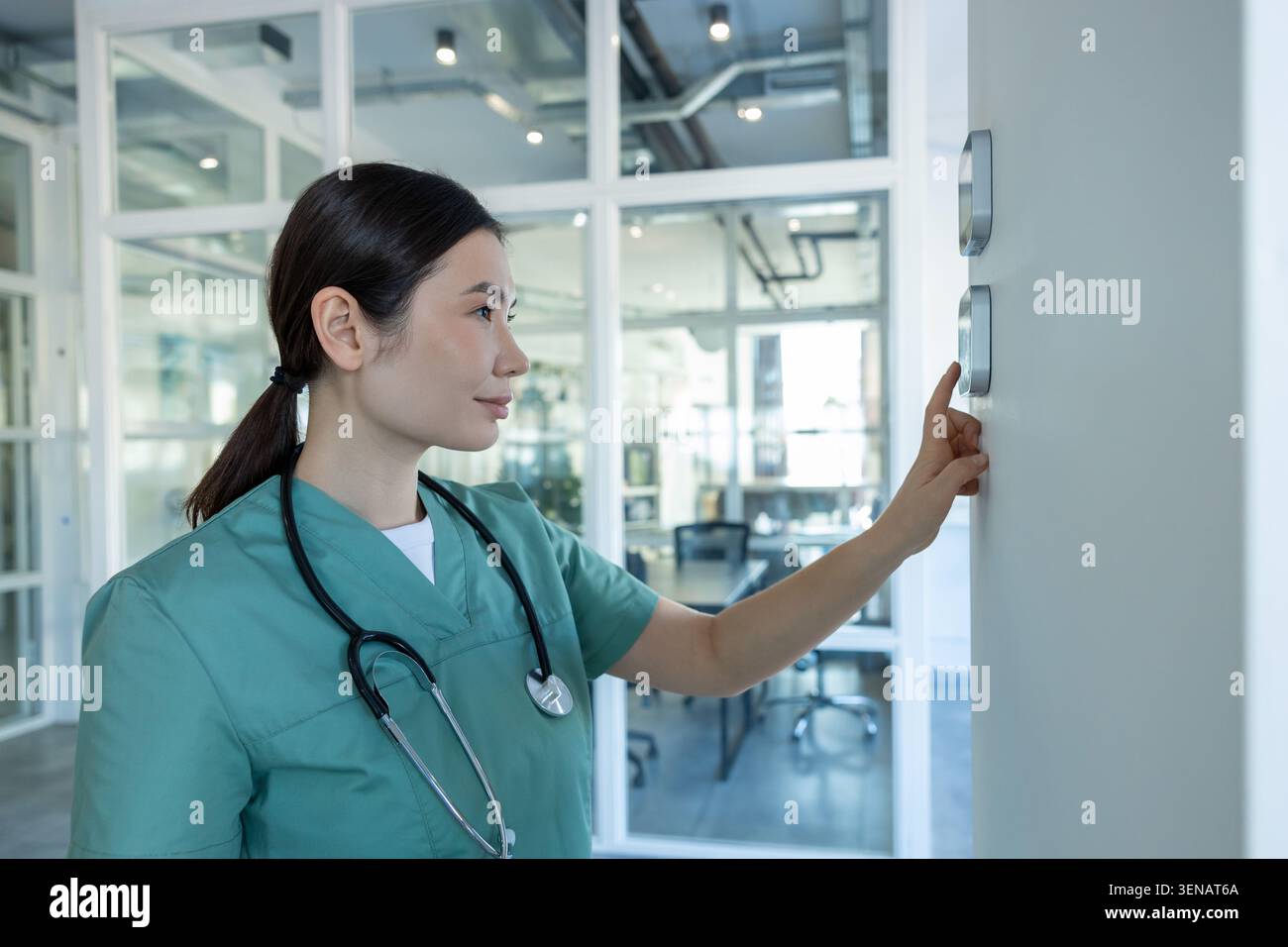 Climate control. Long-haired woman in a lab coat standing near ...