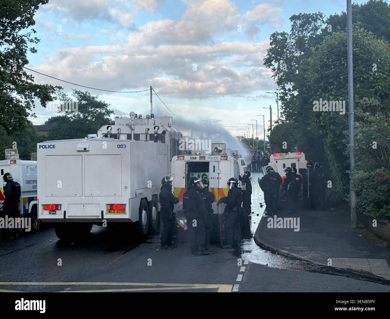 Police fire water cannons at protesters near the Sandyknowes roundabout ...