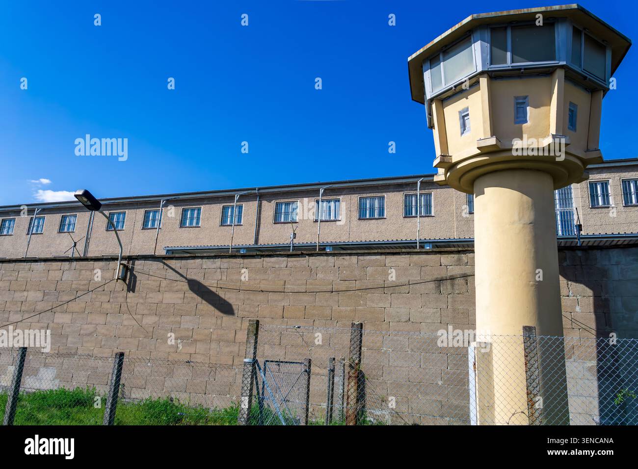 Historic watchtower rising above the security wall of the former ...