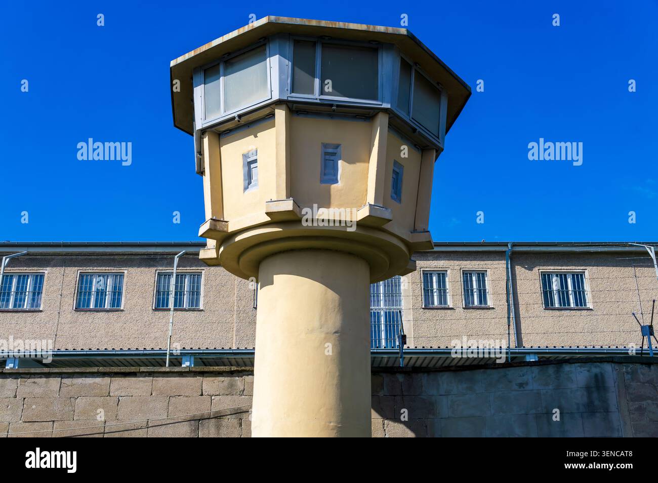 Historic watchtower rising above the security wall of the former ...