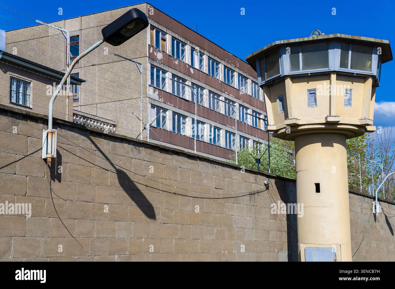 Historic watchtower rising above the security wall of the former ...