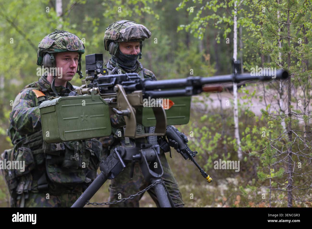 Two Finnish soldiers man a DShK heavy machine gun during exercise ...