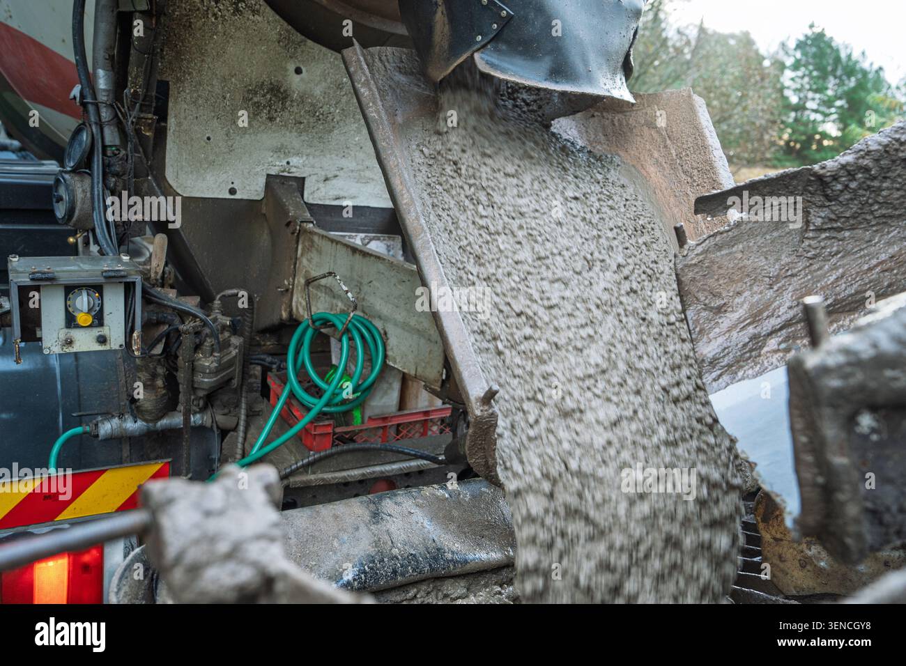 Mixer truck pouring concrete on a roadworks construction site in ...