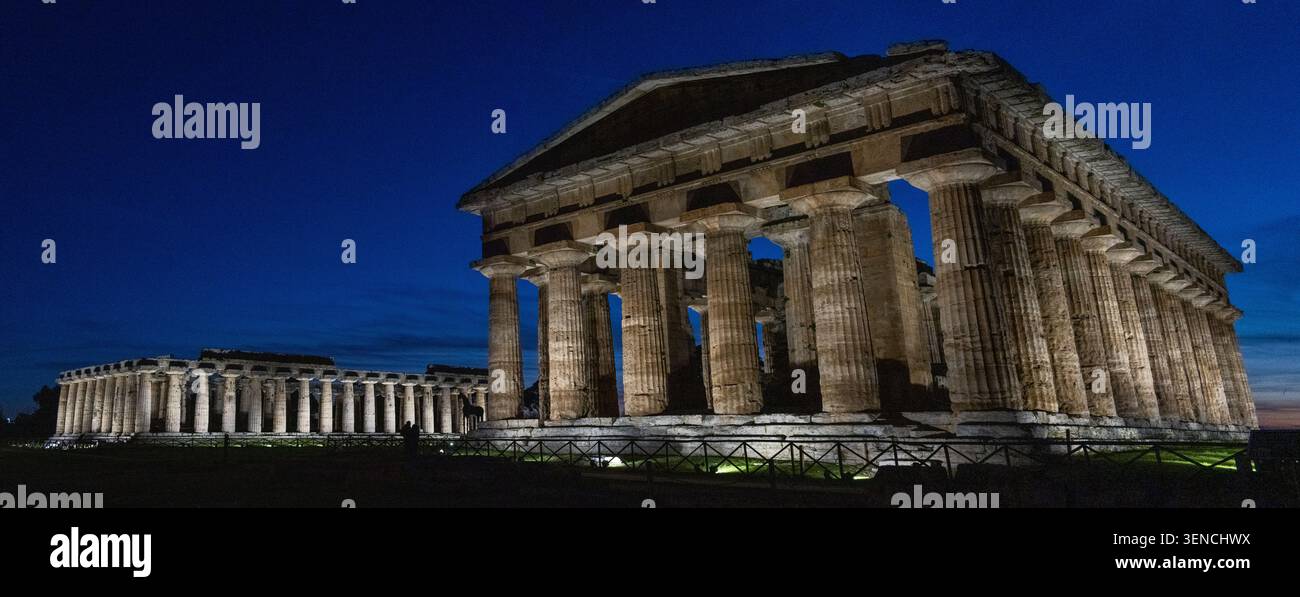Wide panoramic view of illuminated ancient Greek temples at Paestum ...