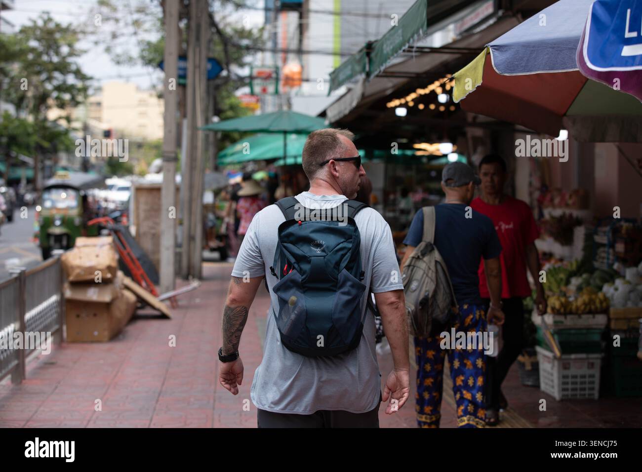 BANGKOK, THAILAND - MAY 23, 2026: Male backpacker exploring flower ...
