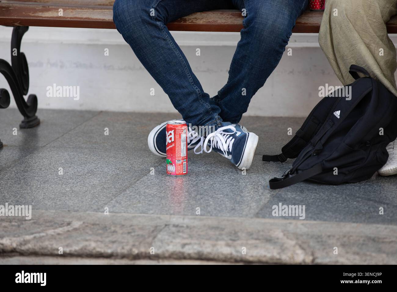 BANGKOK, THAILAND - MAY 23, 2026: Man in jeans and sneakers sitting in ...