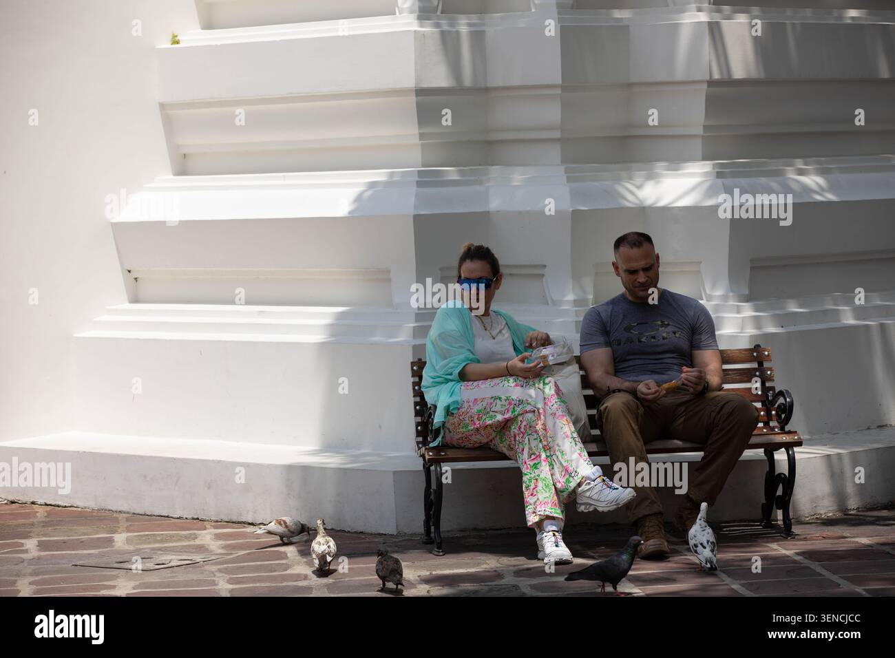 BANGKOK, THAILAND - MAY 23, 2026: Tourist couple resting in Thai temple ...