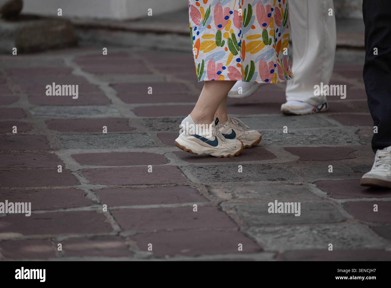 BANGKOK, THAILAND - MAY 23, 2026: Woman walking and stepping on heels ...