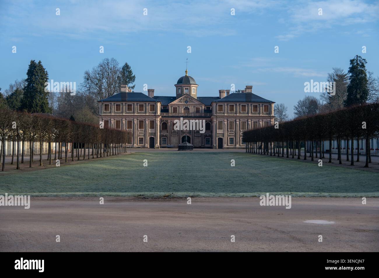 Front view of Schloss Favorite baroque palace framed by tree-lined ...