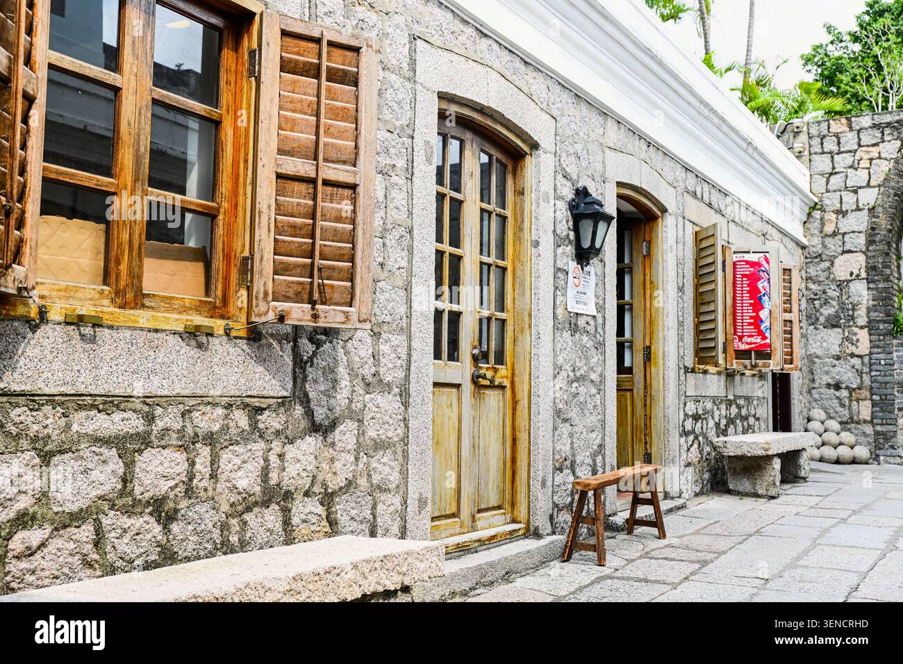 Macau, China April 13, 2026 Historic stone building facade with wooden ...