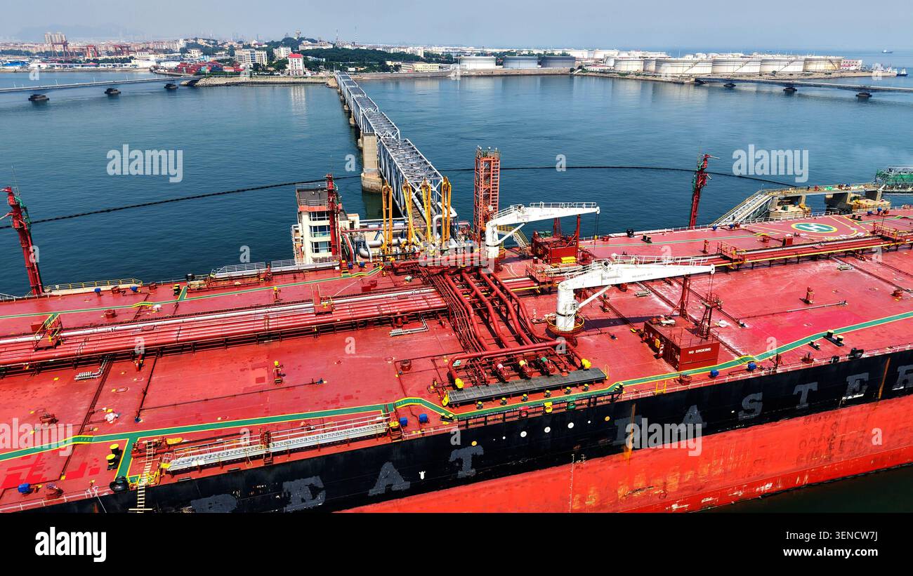 An oil tanker unloads imported crude oil at Qingdao Port in east China ...