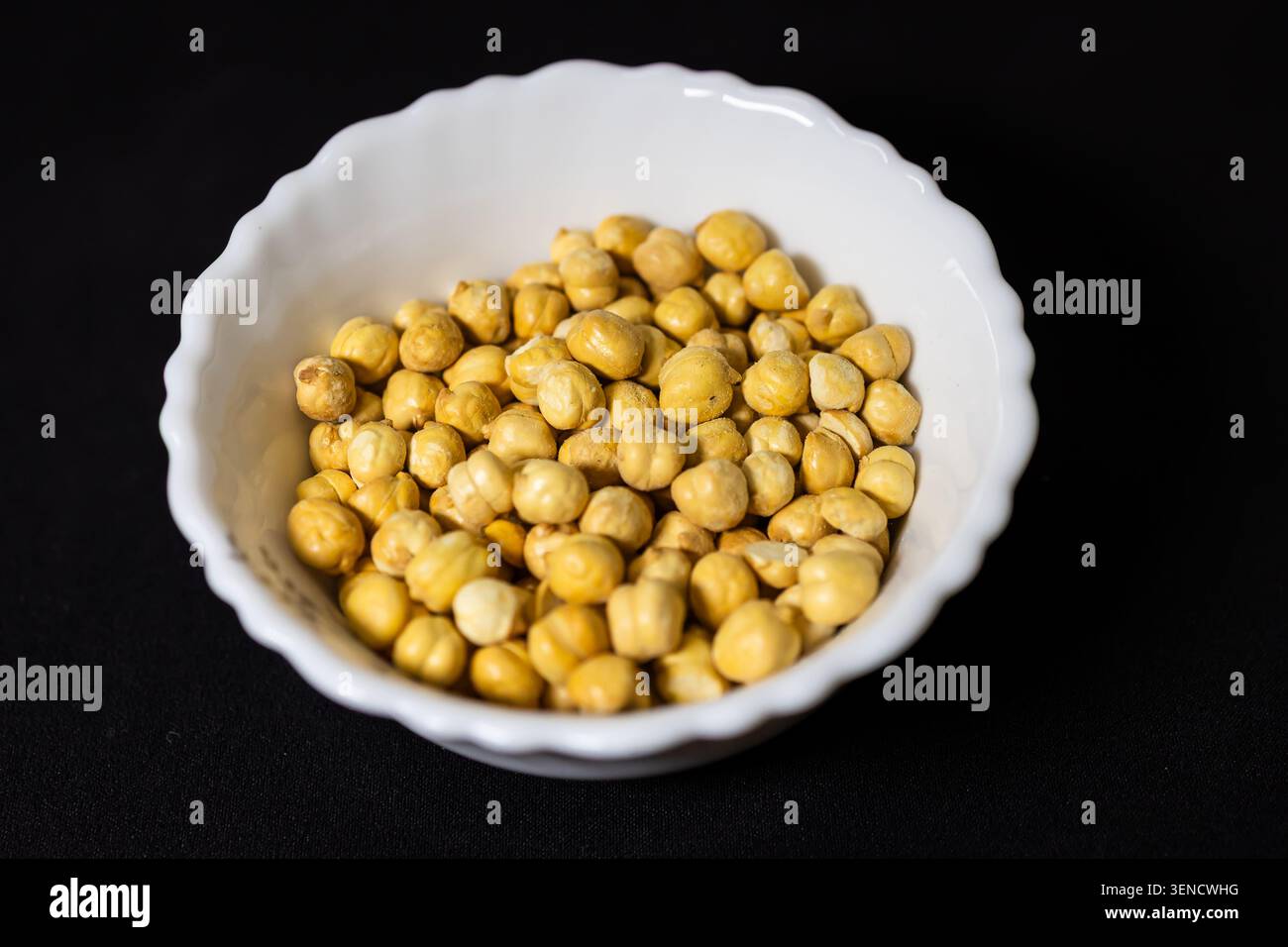 close up of protein rich roasted gram beans arranged in serving bowl on ...