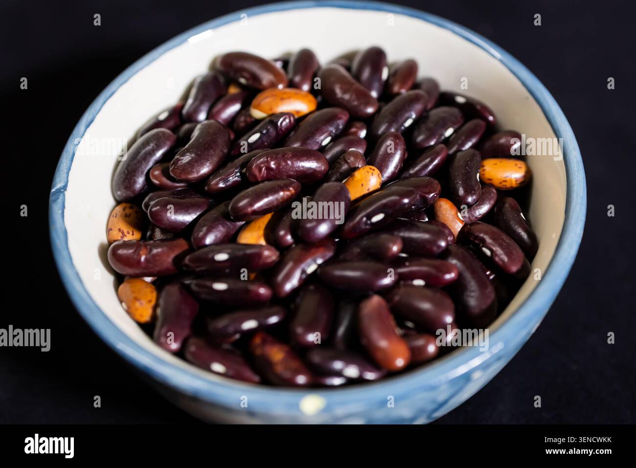 protein rich red beans displayed in bowl isolated against black ...