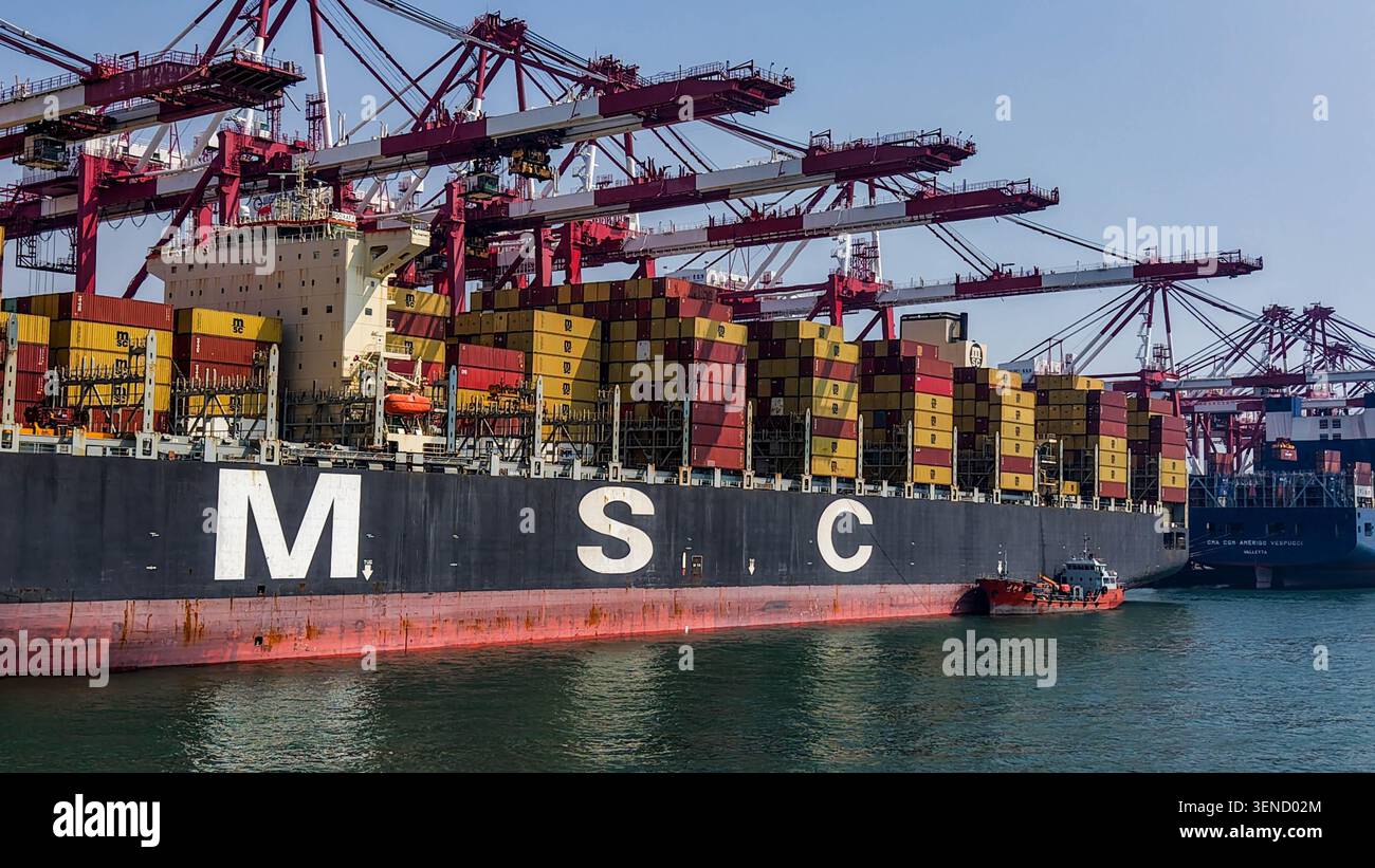 Workers handle cargo at Qingdao Port in east China's Shandong Province ...