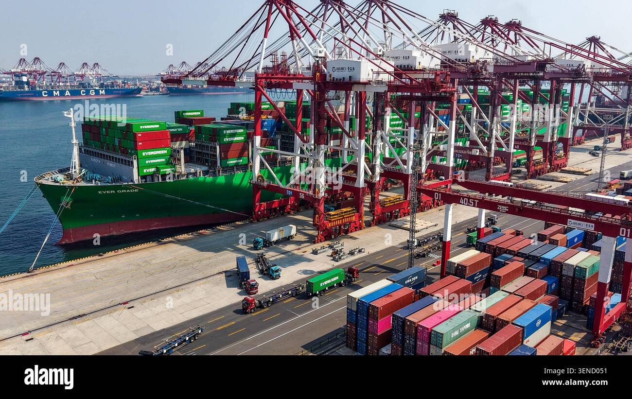 Workers handle cargo at Qingdao Port in east China's Shandong Province ...